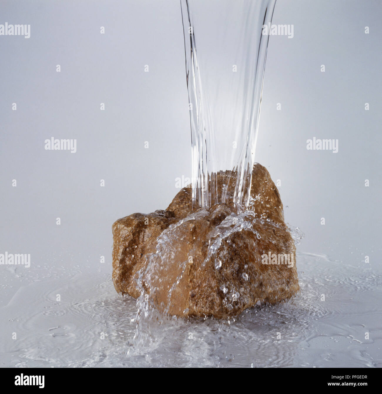Water splashing onto rock Stock Photo - Alamy