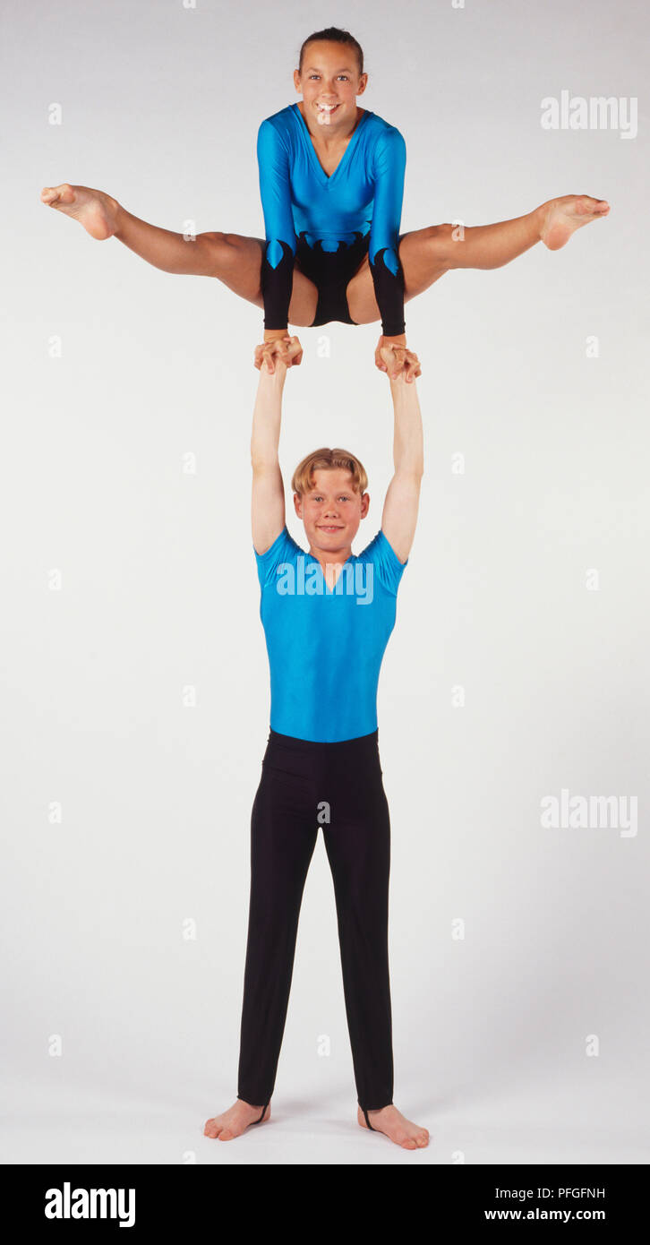 Boy balancing girl Stock Photo - Alamy