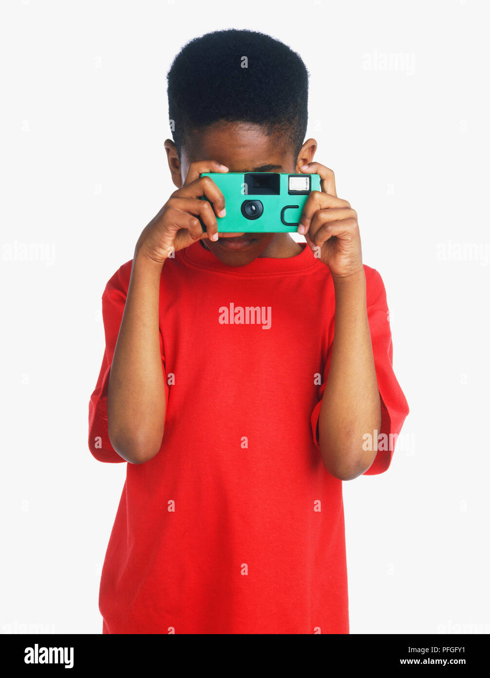 Standing boy taking photograph with green film camera, front view Stock ...