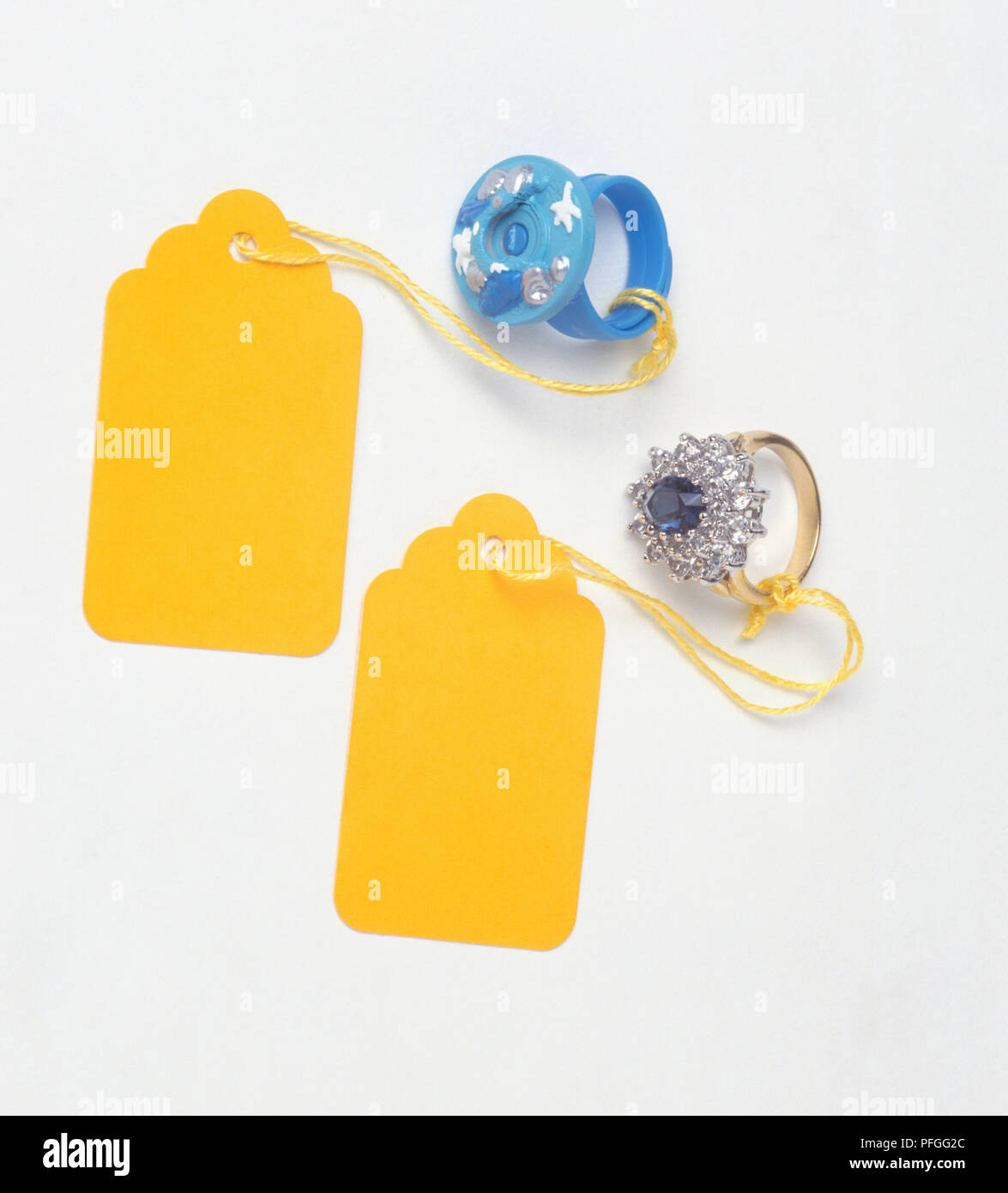 A plastic ring and a diamond ring with blank price tags attached Stock ...