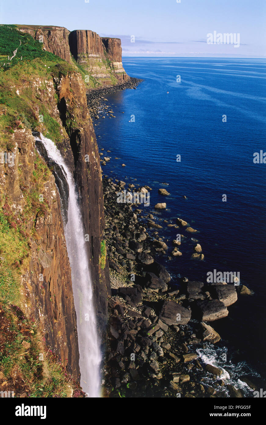 Great Britain, Scotland, a stream plunges over cliffs of hexagonal ...