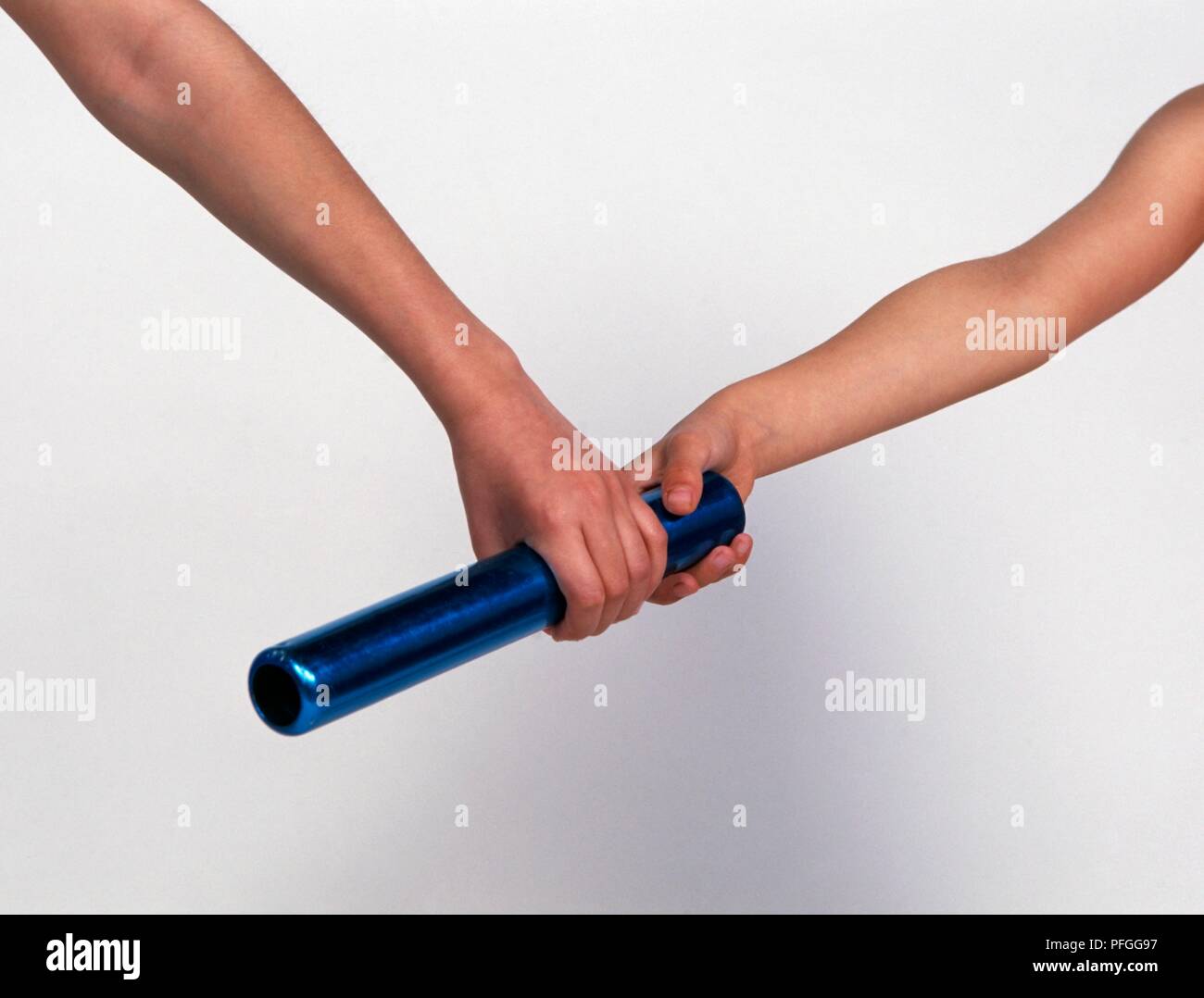 Relay baton being passed from one hand to another, close-up Stock Photo ...