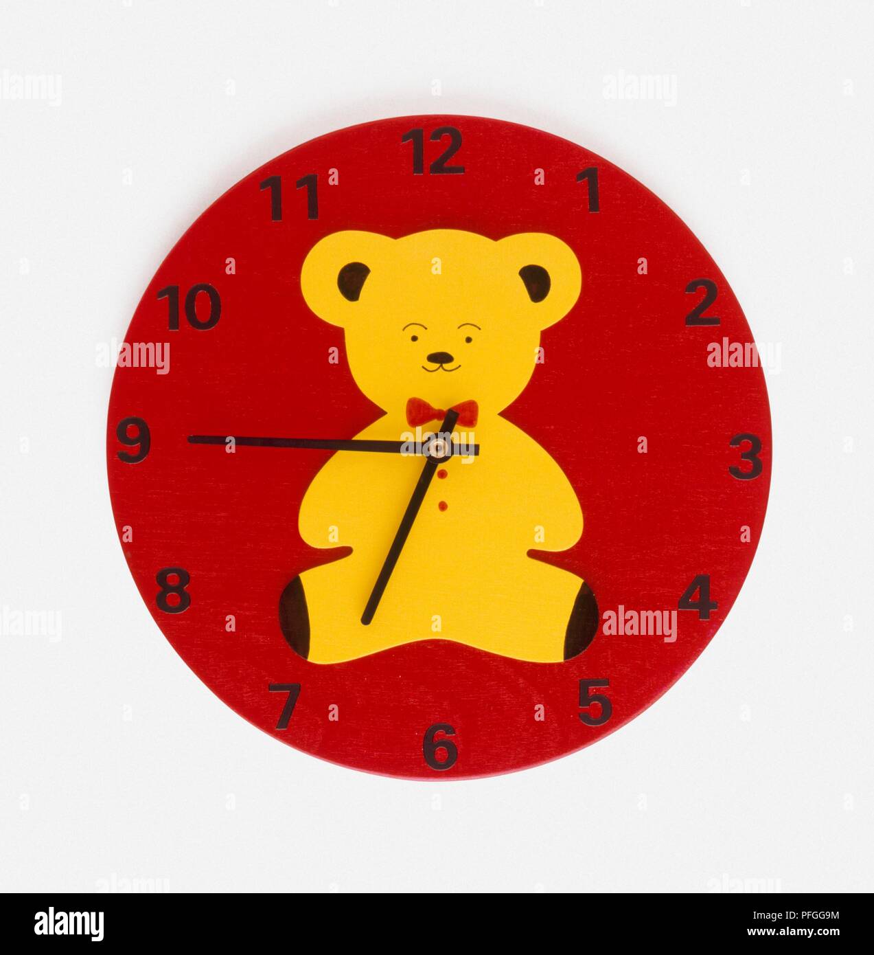 Red wall clock with yellow teddy on face, front view Stock Photo - Alamy