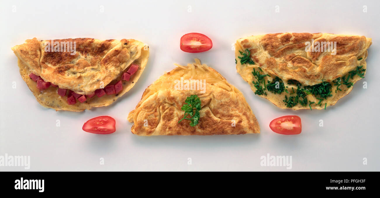 Above view of three different types of Omelettes, Ham, Cheese and Herb ...