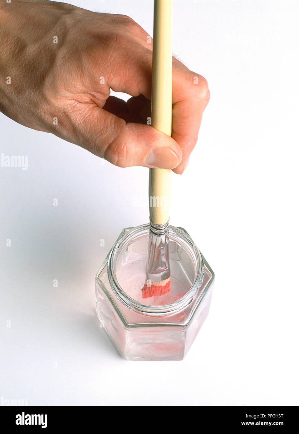 Dipping paint brush in a jar of water Stock Photo - Alamy