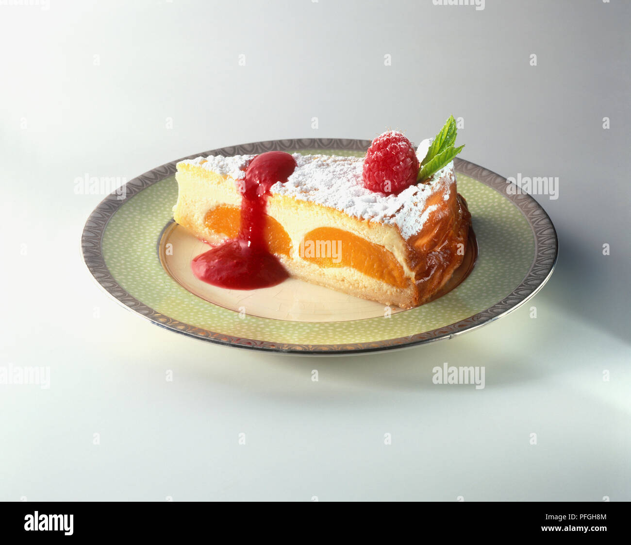 Slice of Peche a la Melba, peach cheesecake served on plate Stock Photo ...