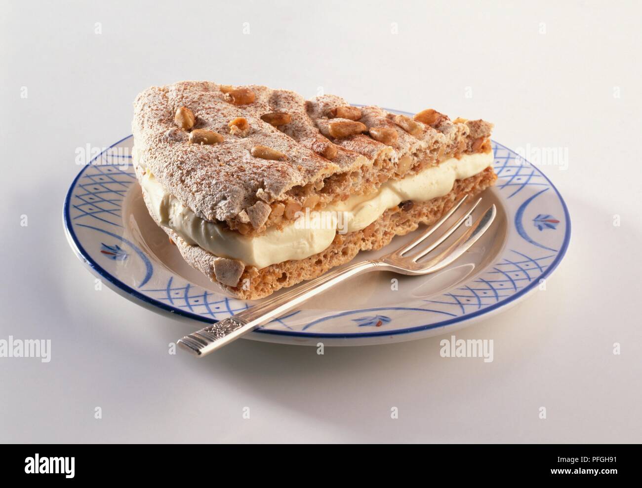 Torta di Pinoli, pine nut tart filled with cream, slice on a plate ...