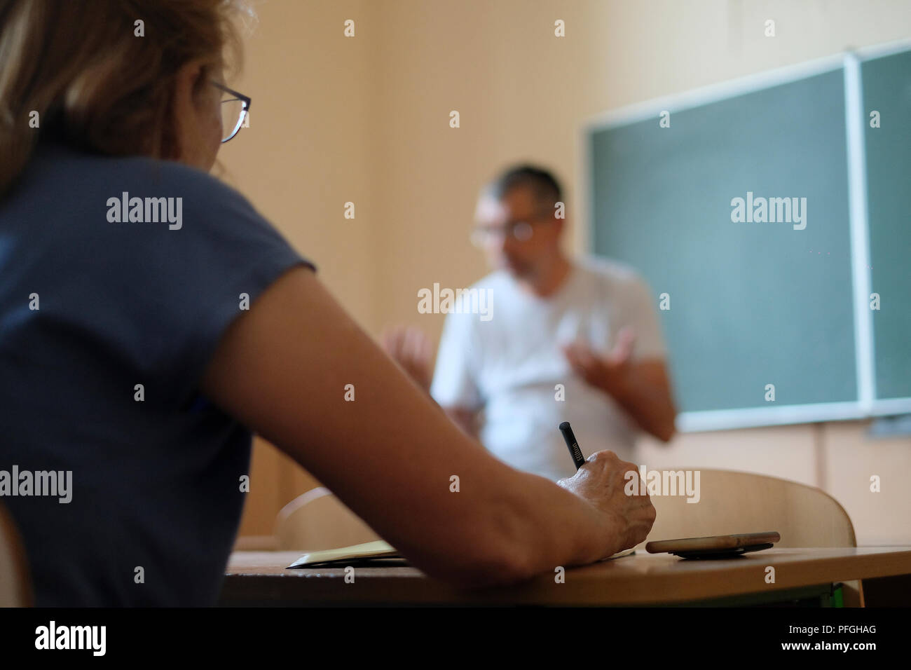 Adults having a lecture Stock Photo - Alamy