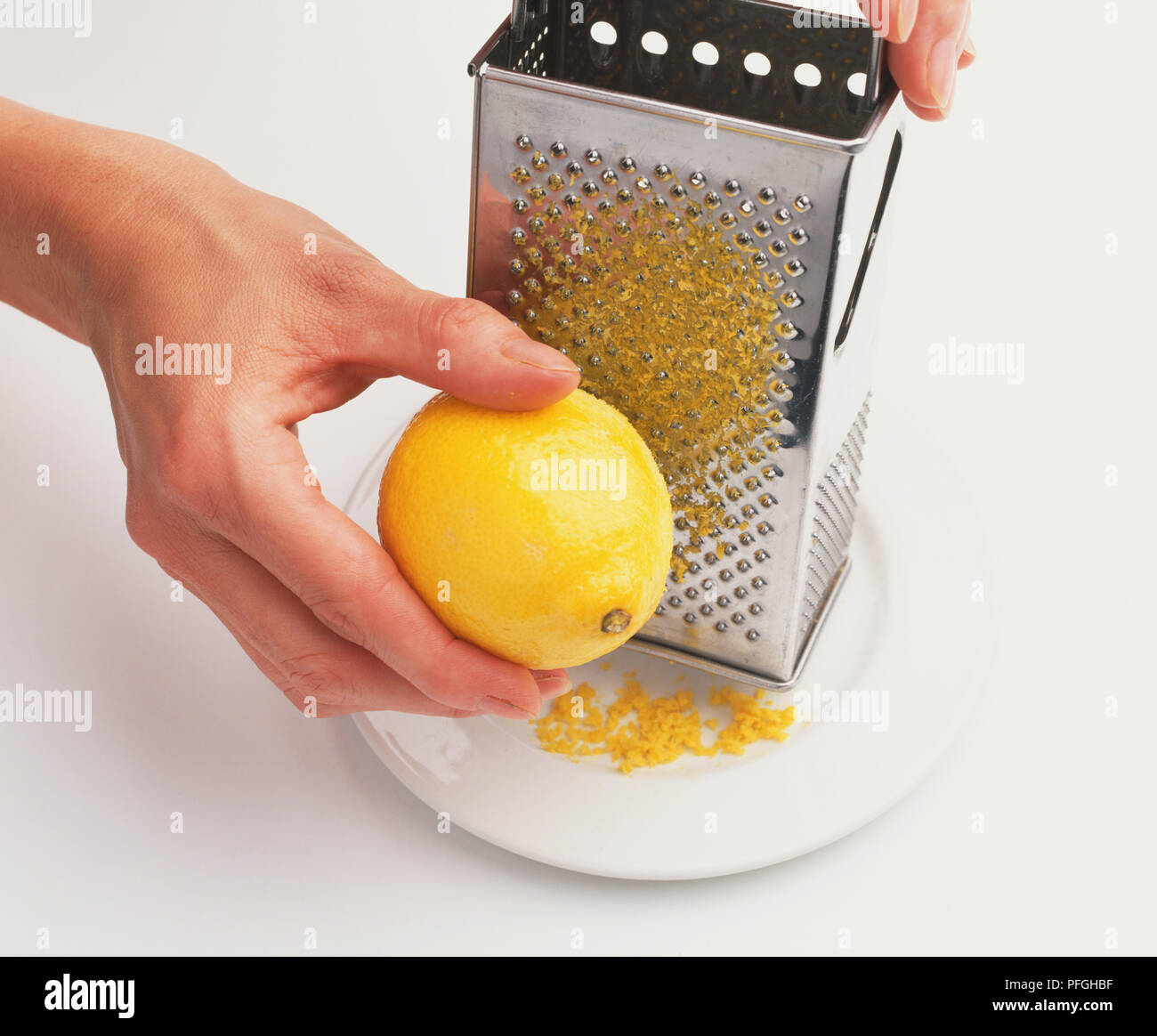 Grating Lemon onto Plate Stock Photo - Alamy
