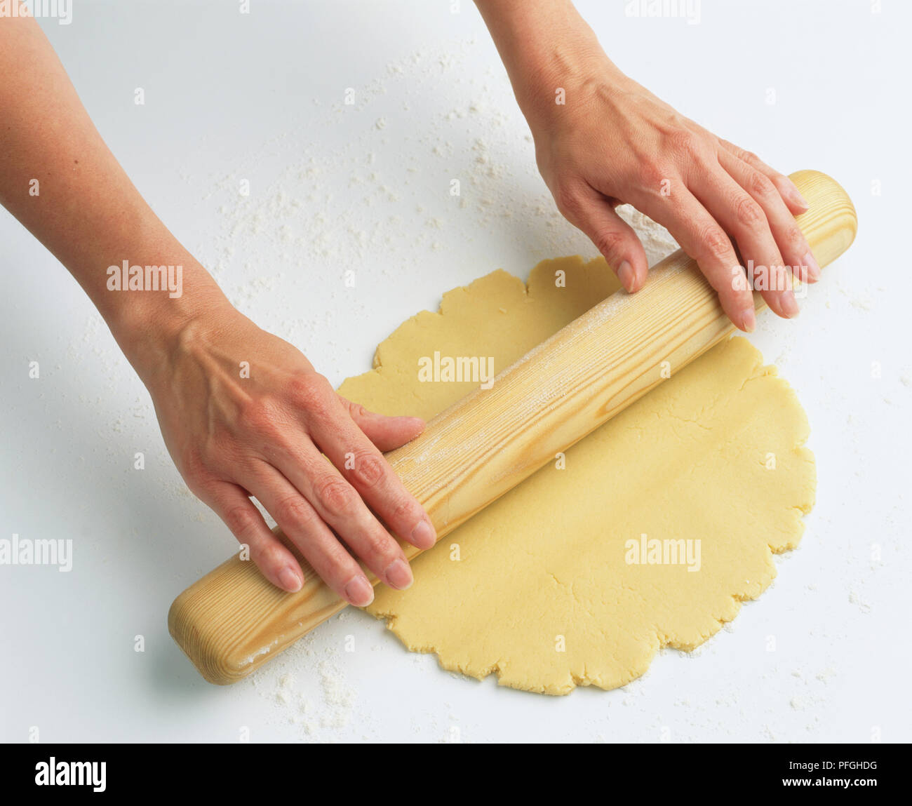 Flattening out pastry dough with rolling pin, view from above Stock ...