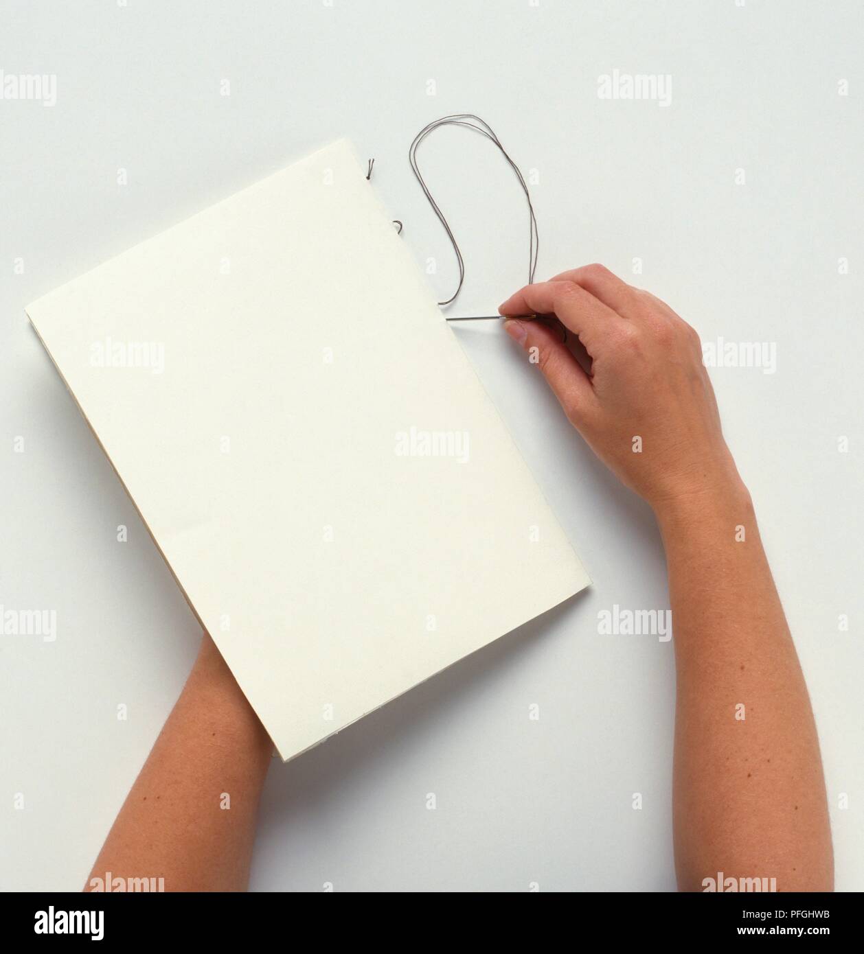 Making a sketchbook, binding with needle and thread, close-up Stock ...