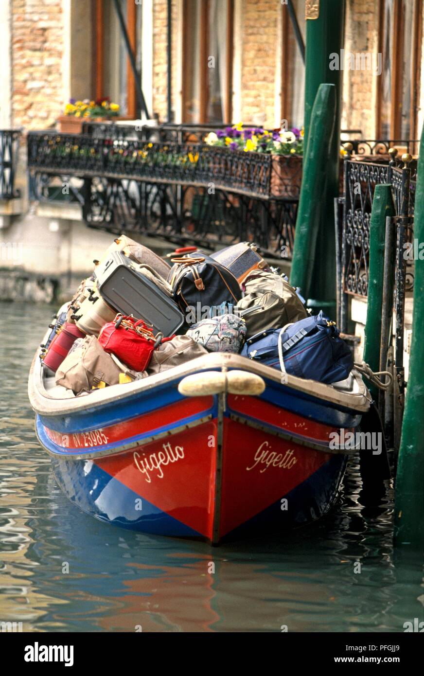 Italy, Venice, suitcase boat transporting visitors' luggage, close-up ...