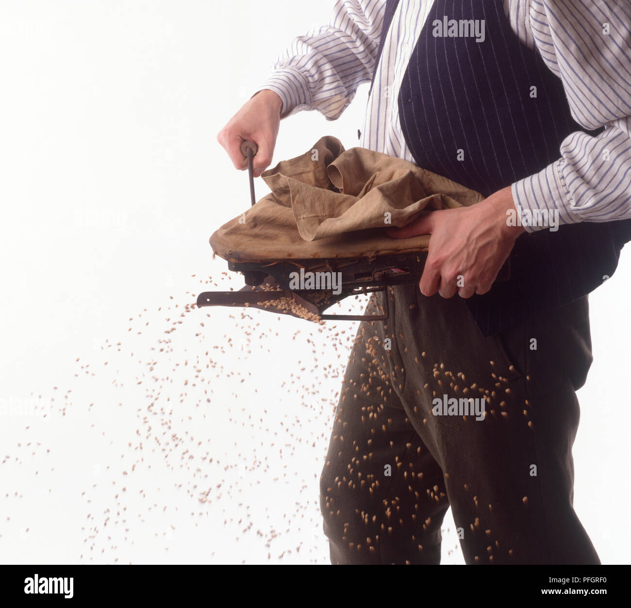 A 19th century seed scatterer being worked by a man Stock Photo - Alamy