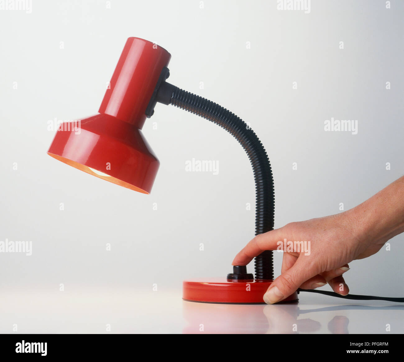 Man's hand switching off desk lamp Stock Photo - Alamy