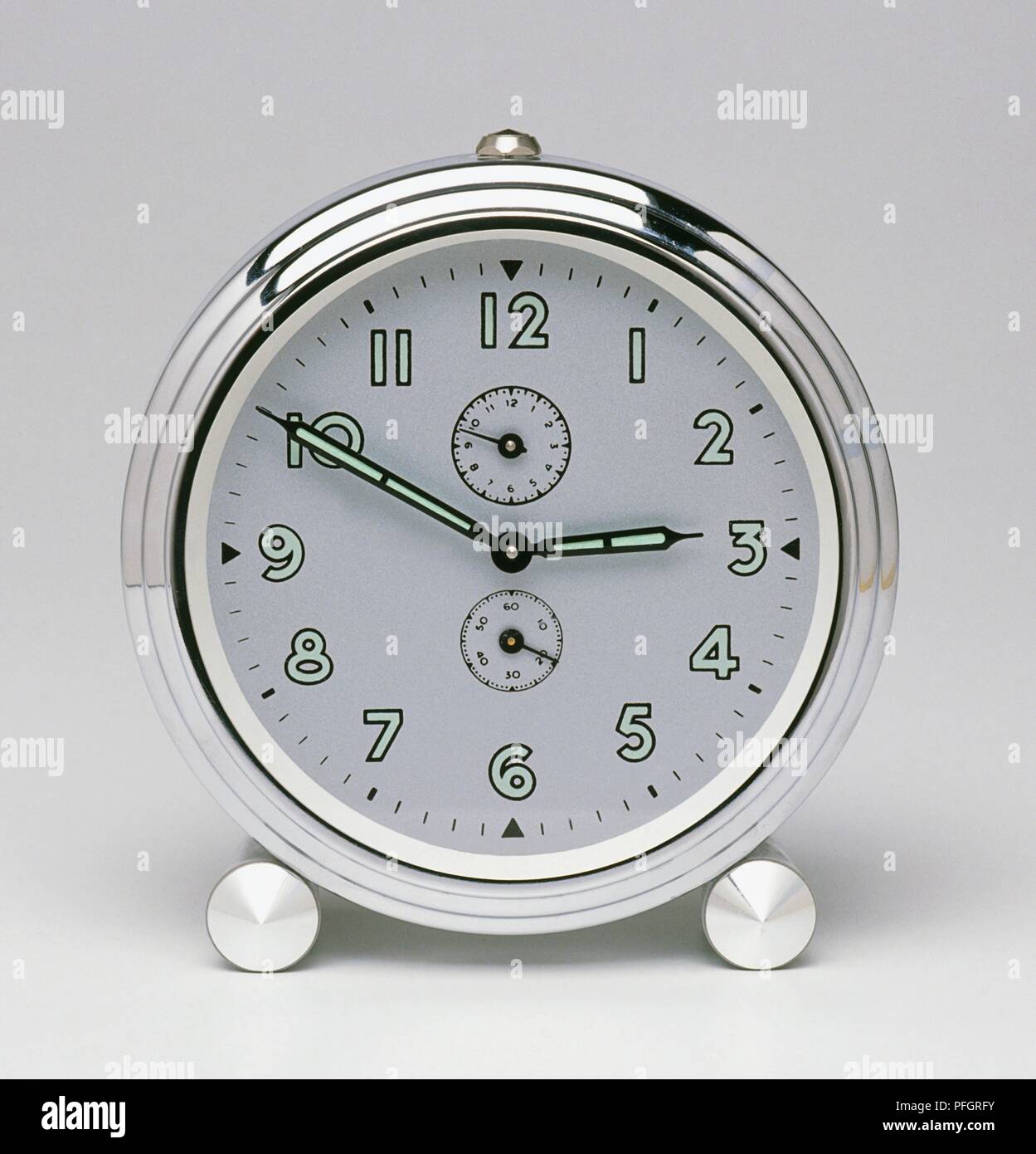 A silver alarm clock, front view Stock Photo - Alamy