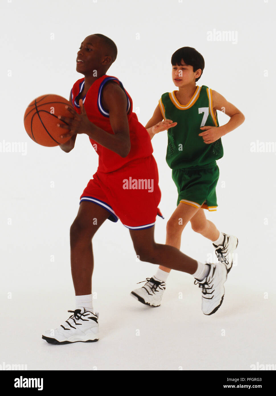 Receiver takes ball and moves off, defender pursues Stock Photo - Alamy