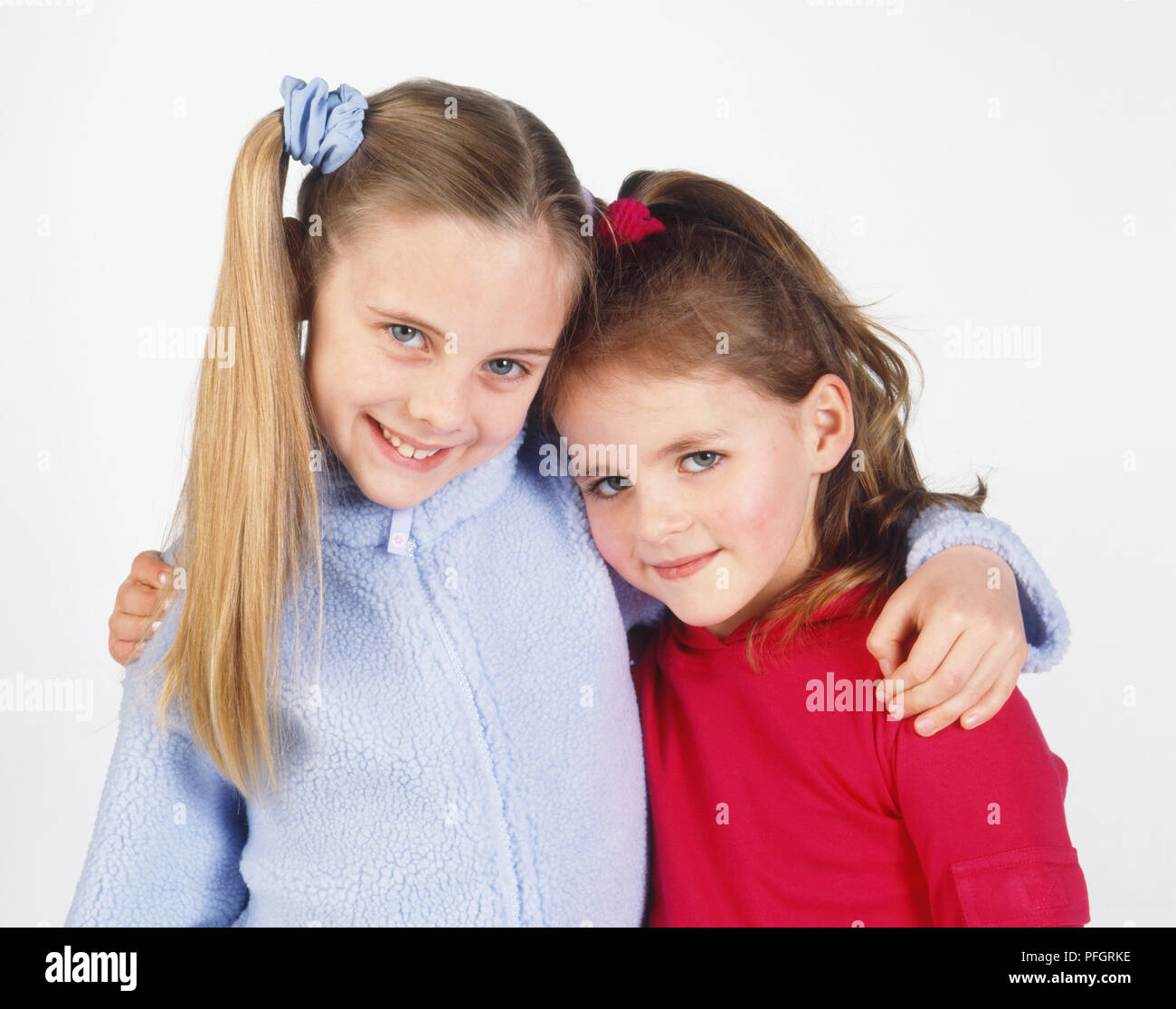 Two girls with arms around each other hi-res stock photography and ...