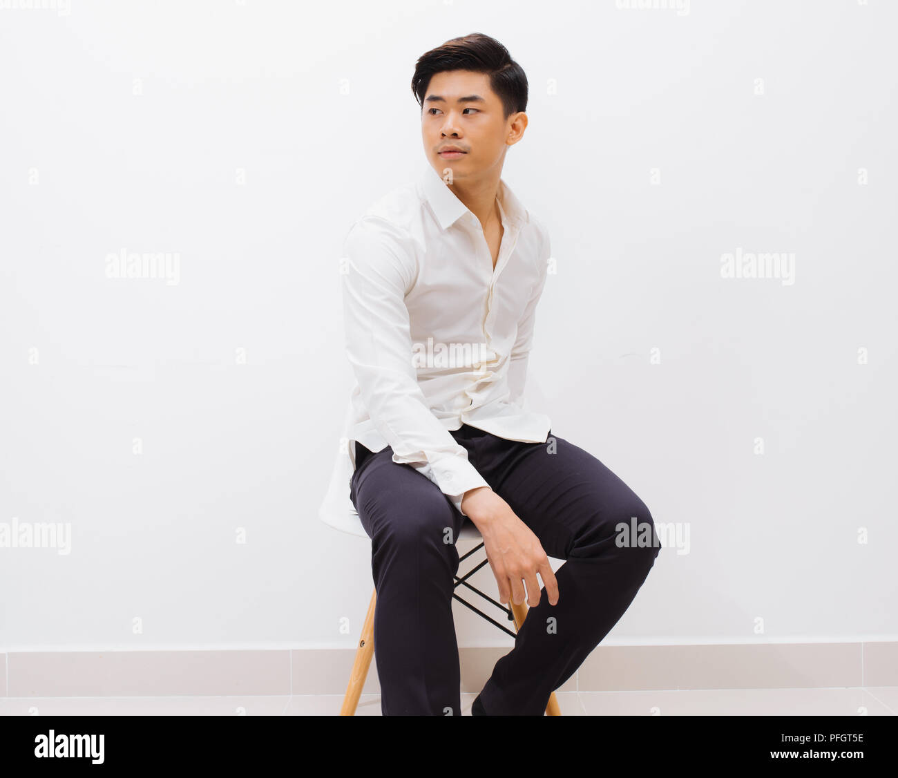 Feeling comfortable anywhere. Handsome young man looking at camera with ...