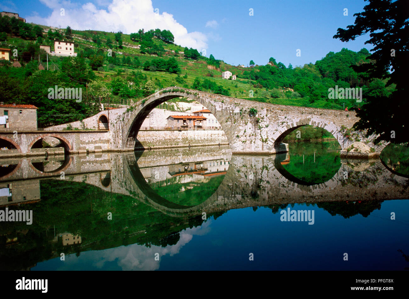 Italy, Tuscany, Lucca, Ponte Maddalena, Devil's Bridge reflected in the ...