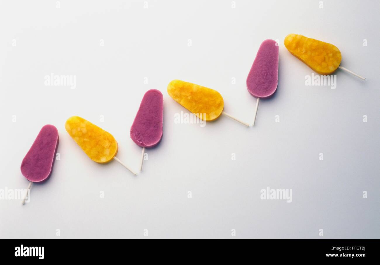 Six ice lollies in a row coloured yellow and pink Stock Photo - Alamy