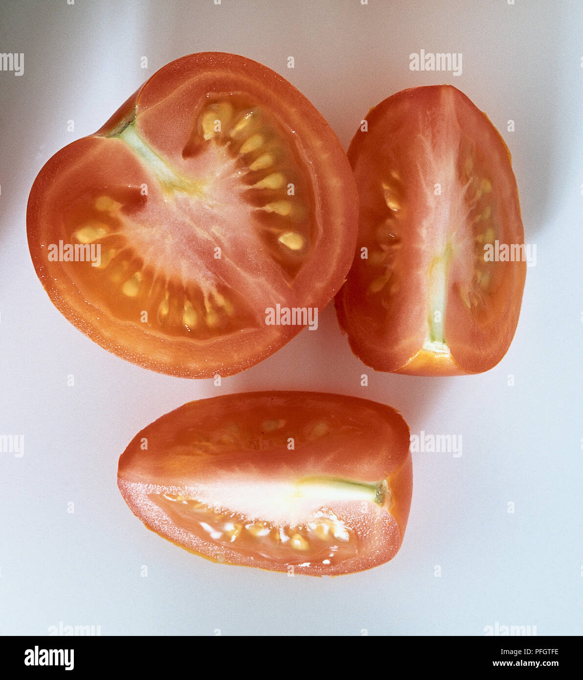 Tomato cut in half and quarters Stock Photo - Alamy