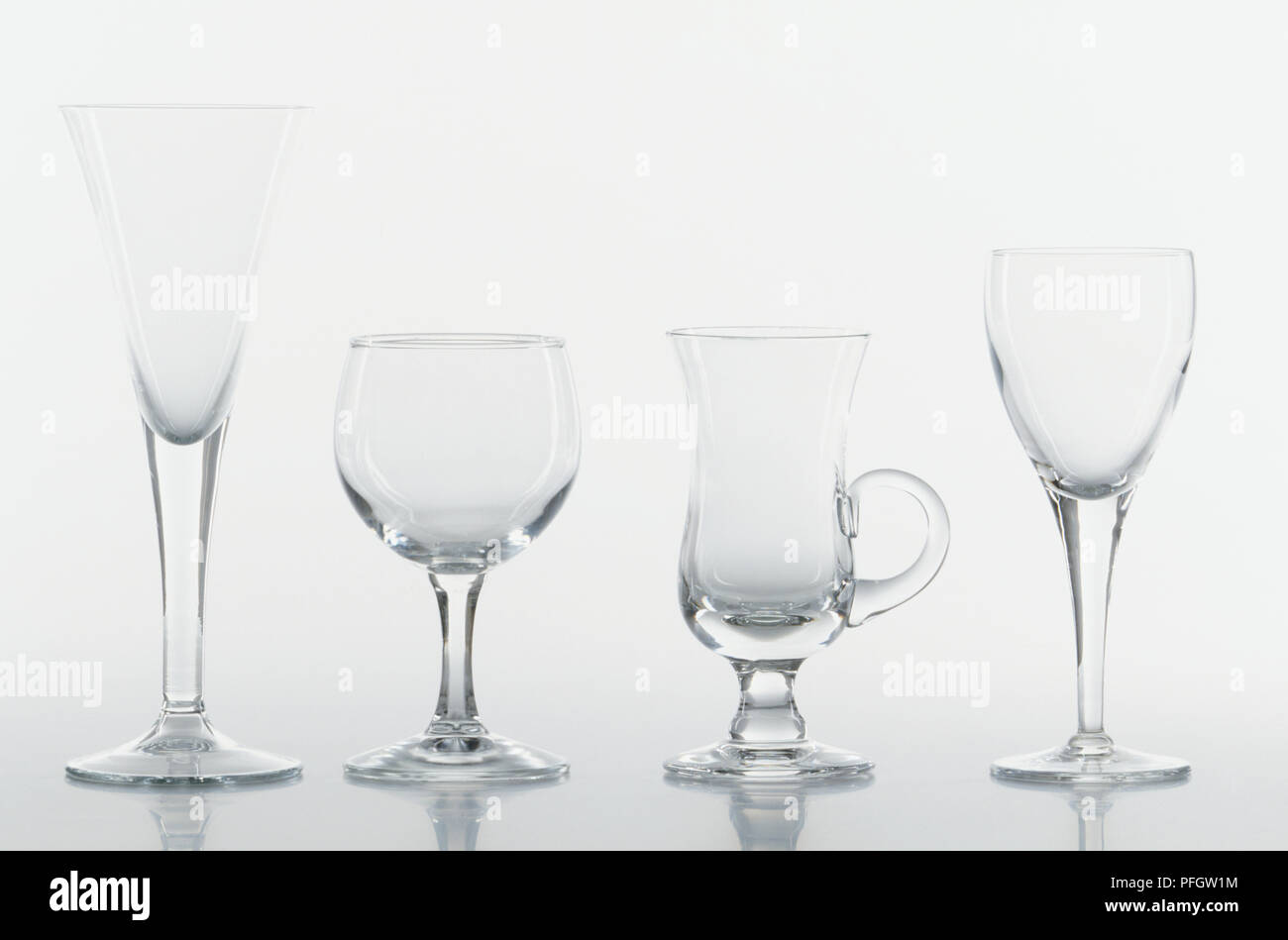 Four different drinking glasses in a row Stock Photo - Alamy