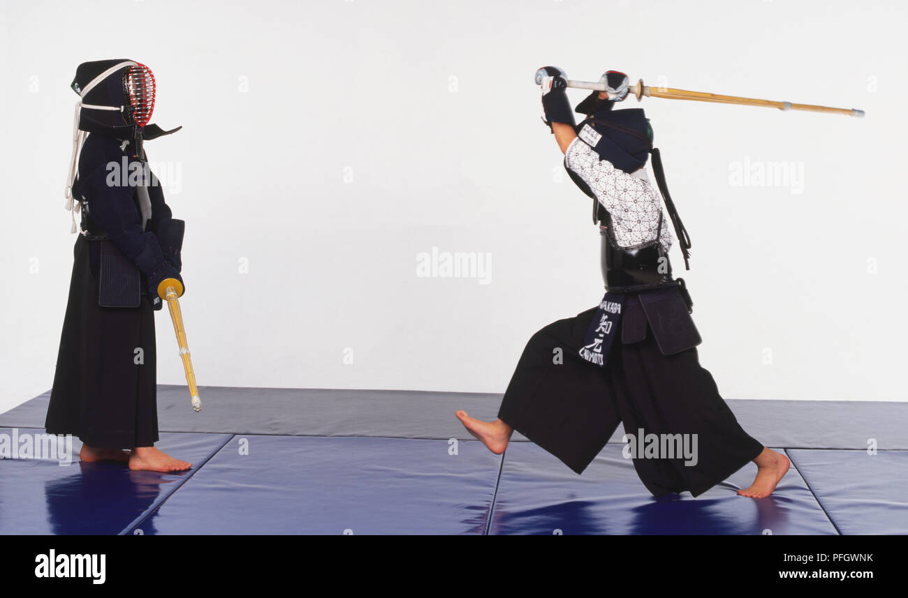 Bringing the sword overhead to attack the opponent Stock Photo - Alamy
