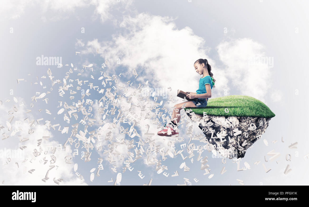 Girl of school age reading book as concept for education Stock Photo ...