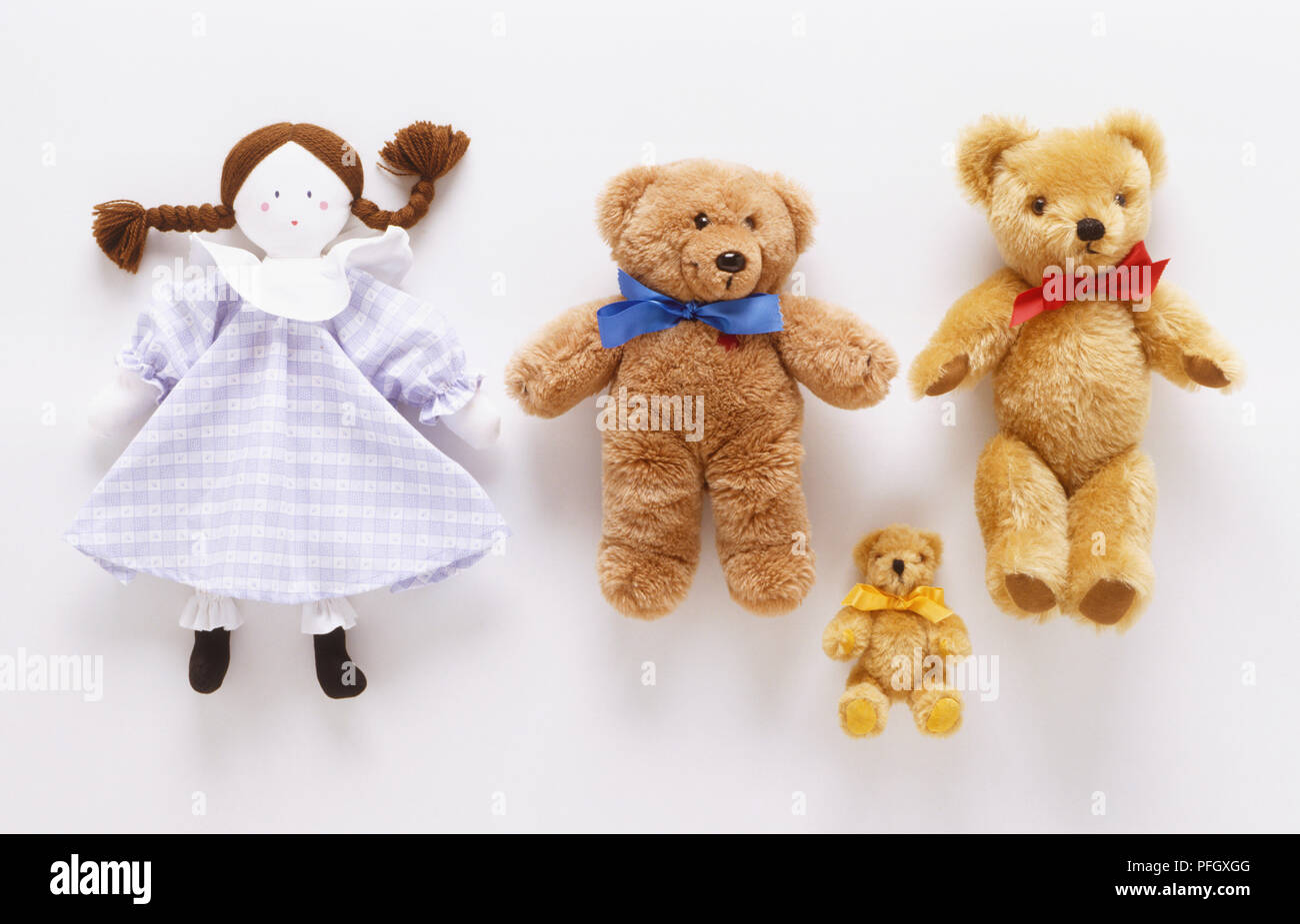 A light brown teddy bear with a blue ribbon around its neck Stock Photo ...