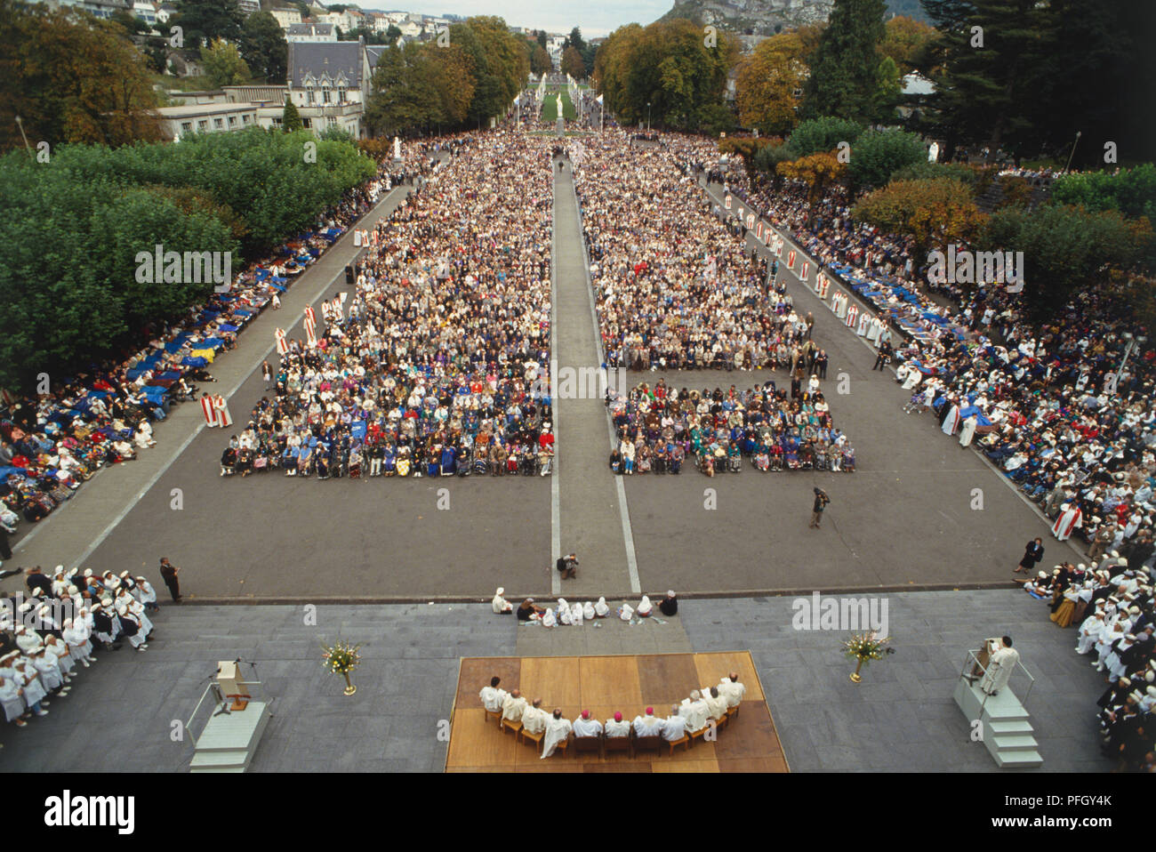 France, Lourdes, pilgrims participating in open-air Mass, elevated view ...
