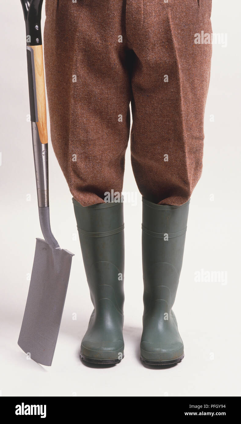 Pair of legs walking, wearing Green Wellington Boots Stock Photo - Alamy