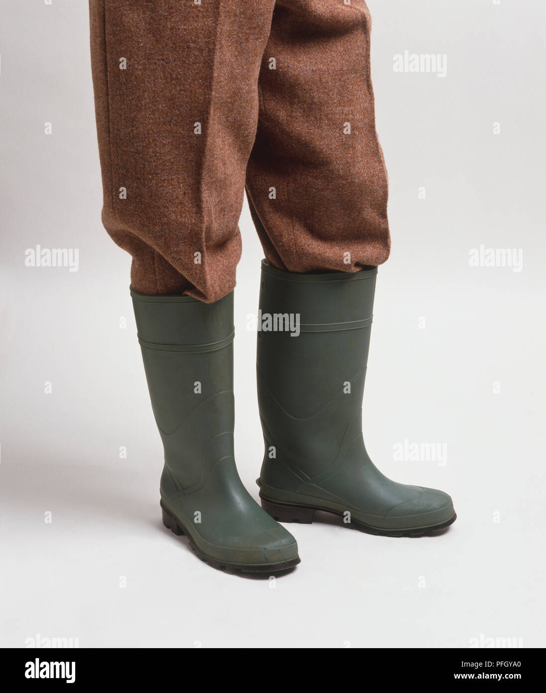 Pair of legs walking, wearing Green Wellington Boots Stock Photo - Alamy