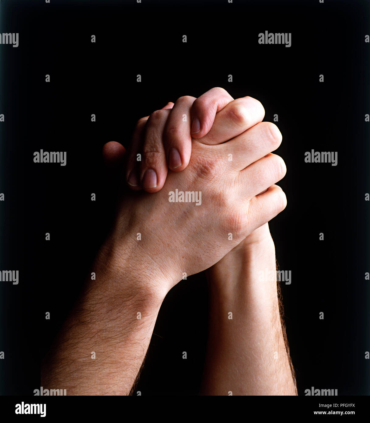 Man clasping hands together, close-up Stock Photo - Alamy
