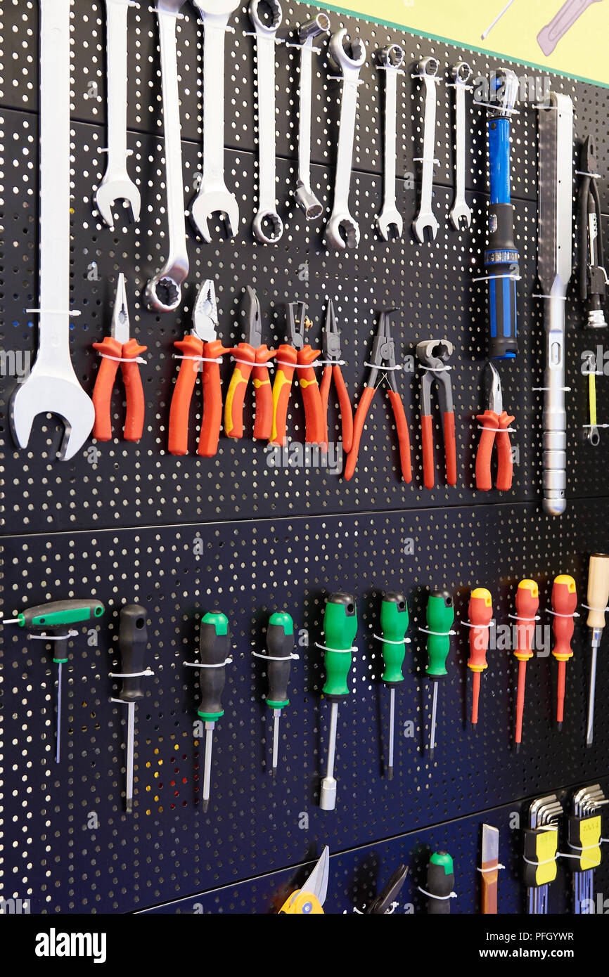Tools on the wall of store Stock Photo - Alamy