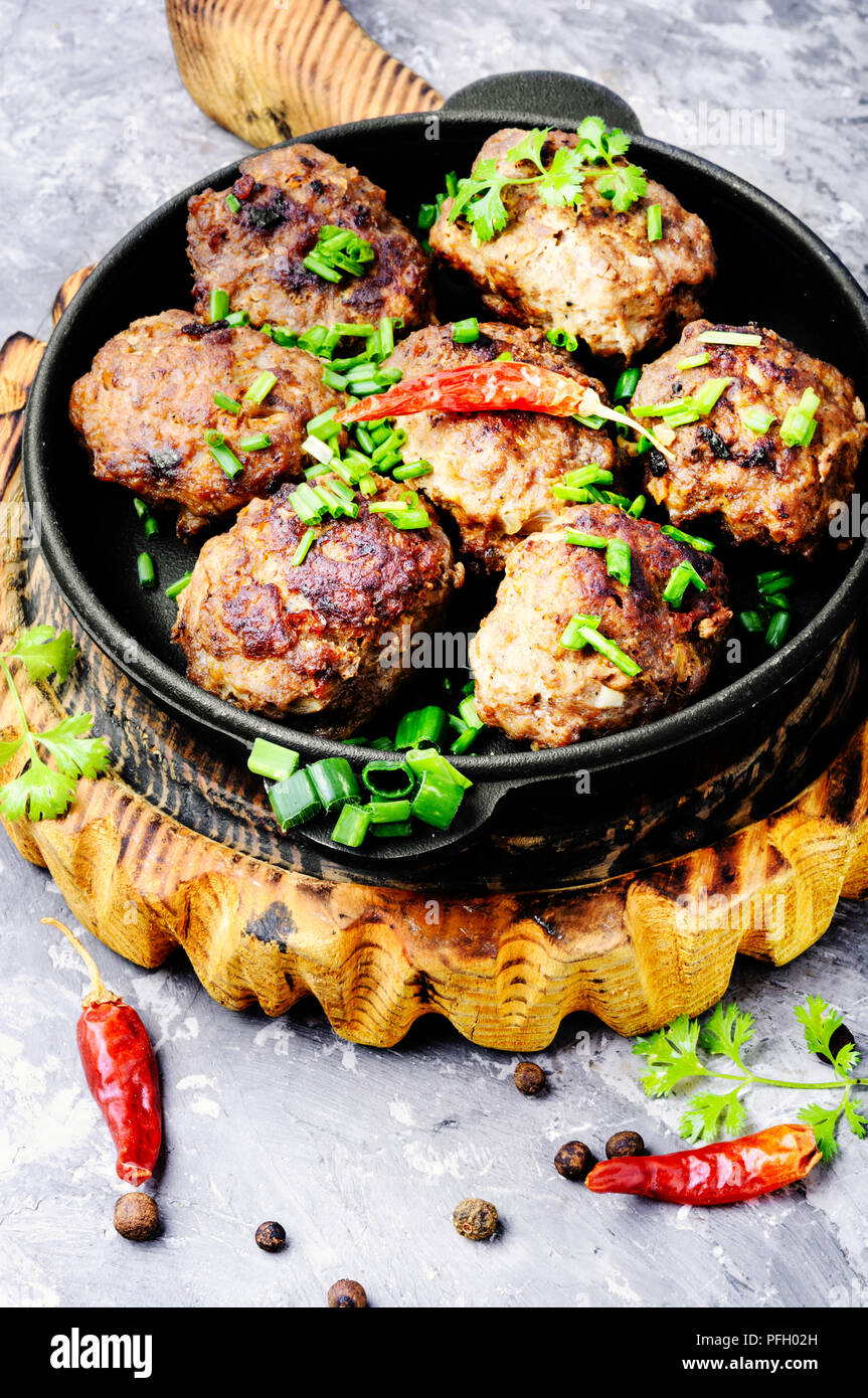 Roasted beef meatballs in cast-iron skillet.Delicious cutlet Stock ...