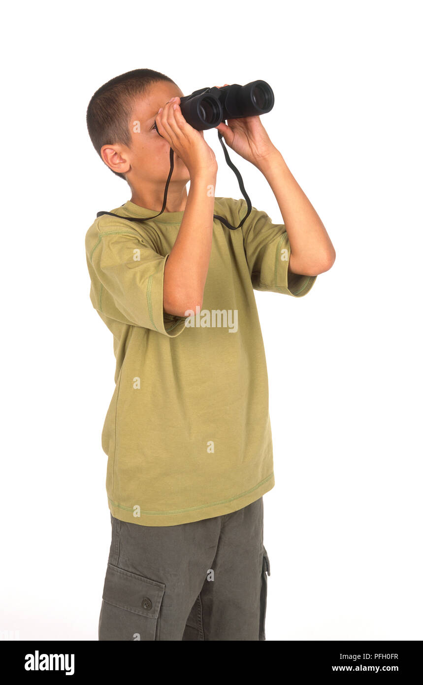 Boy looking through binoculars, close-up Stock Photo - Alamy