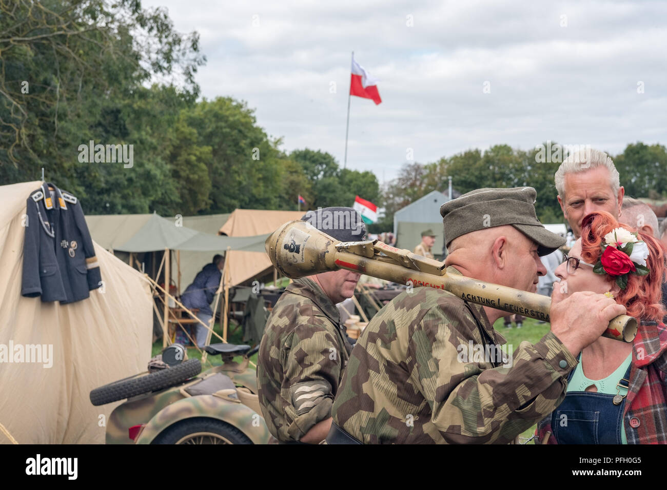 Adult male seen dressed in WW2 Germany army uniform caring a rocket ...