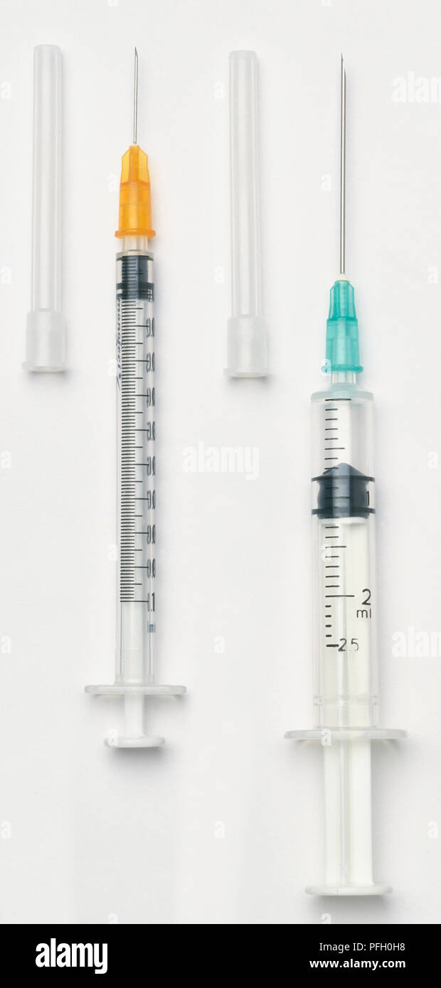 Two syringes with syringe caps Stock Photo - Alamy