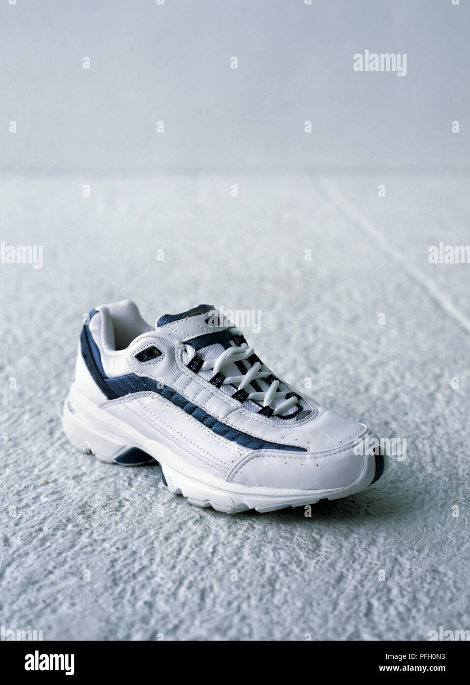 Sports shoe on concrete surface Stock Photo - Alamy