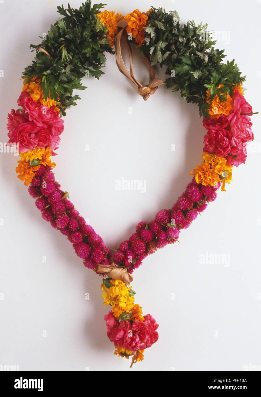 Garland of red, pink and orange flowers Stock Photo - Alamy