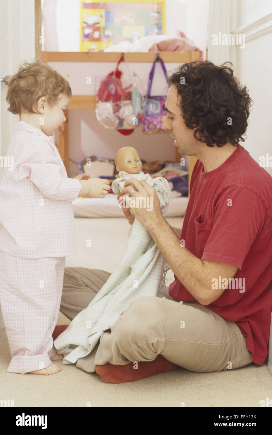 Father showing doll hi-res stock photography and images - Alamy