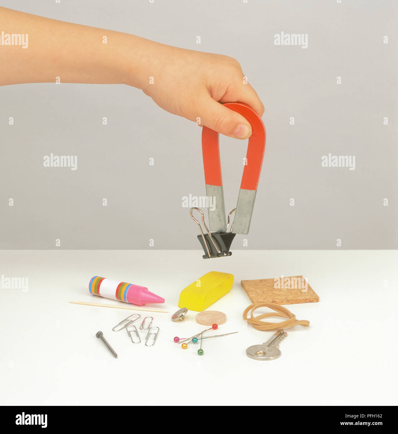 Picking up various items with a magnet Stock Photo - Alamy