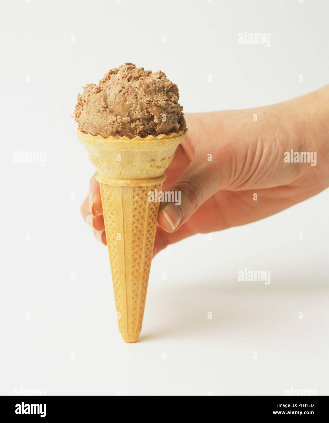 Hand holding ice cream cone with scoop of chocolate ice cream Stock ...