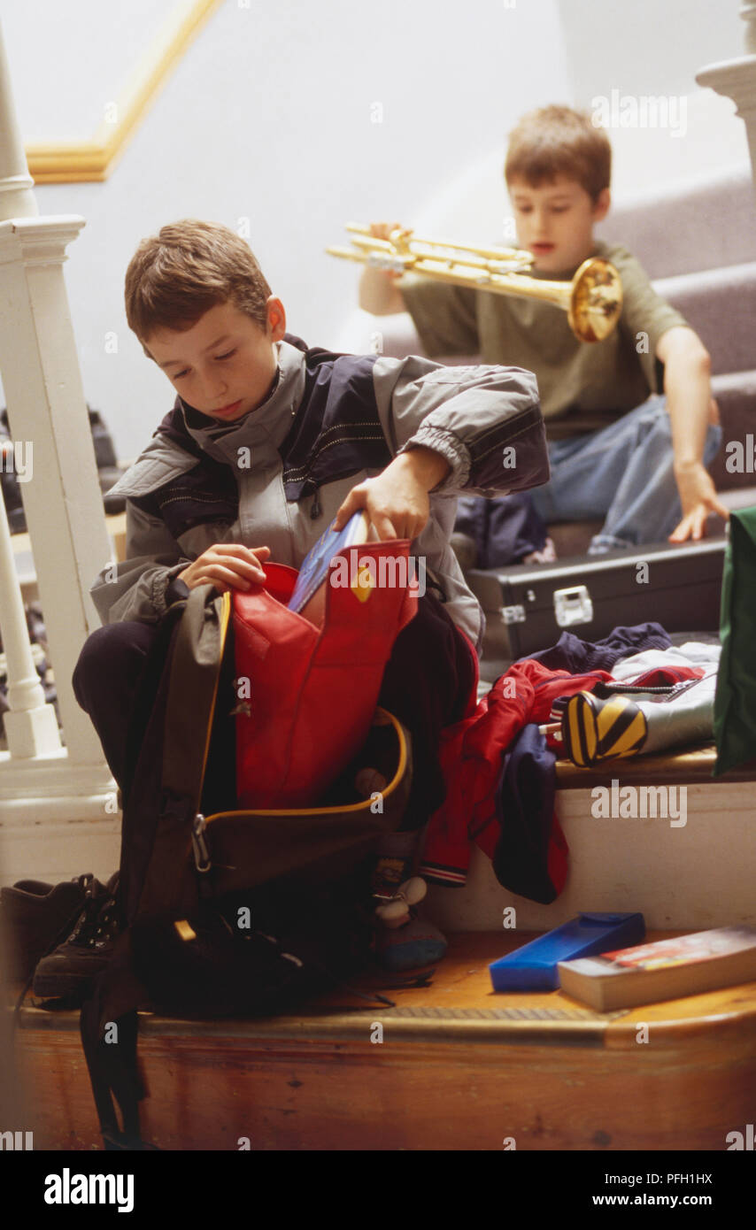 Two boys packing school bags Stock Photo - Alamy