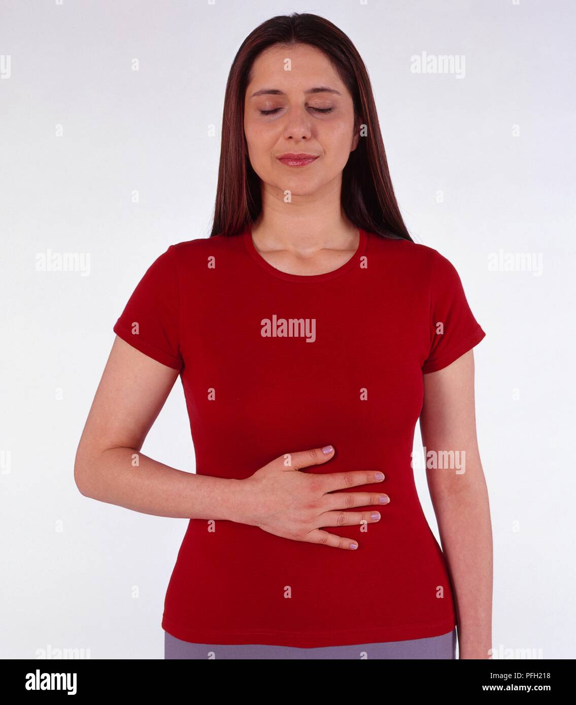 Hand resting on stomach hi-res stock photography and images - Alamy