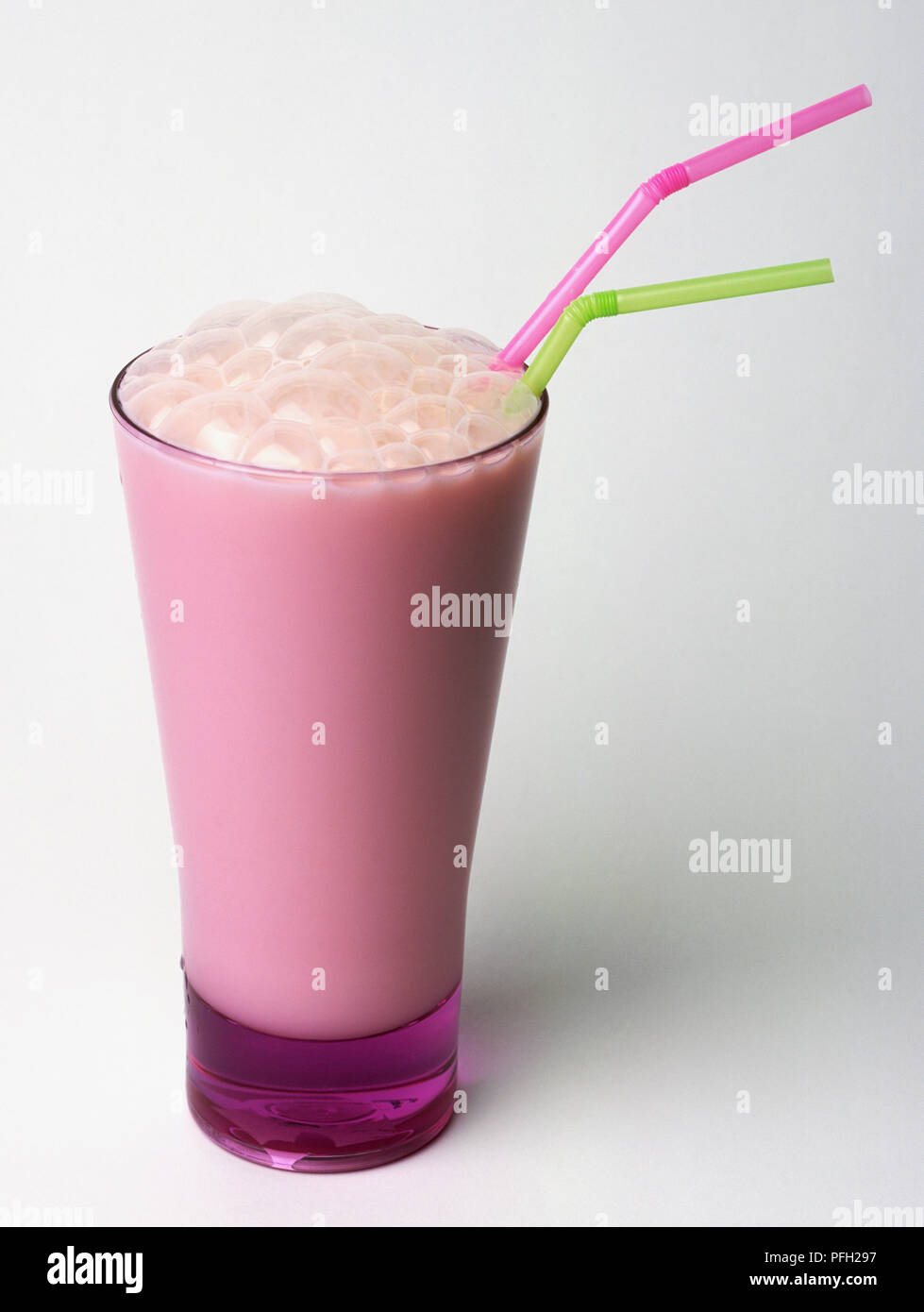 Strawberry milkshake in a glass with a straw Stock Photo - Alamy