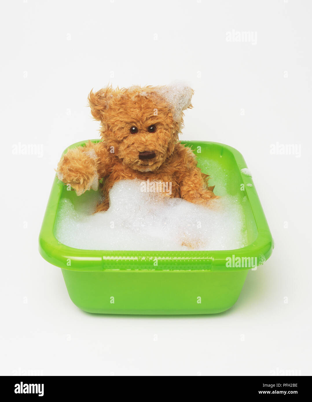 Teddy bear in a green plastic tub, soapy water Stock Photo - Alamy