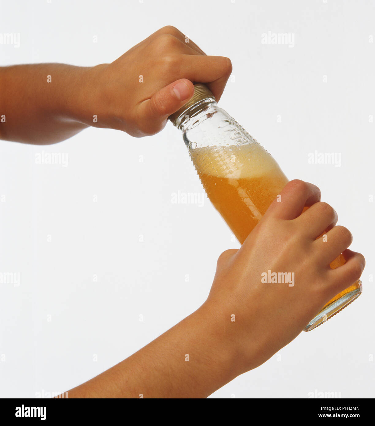 Opening a bottle of orange energy drink Stock Photo - Alamy