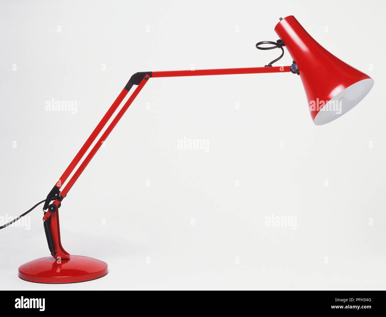 Red metal desk lamp, side view Stock Photo - Alamy
