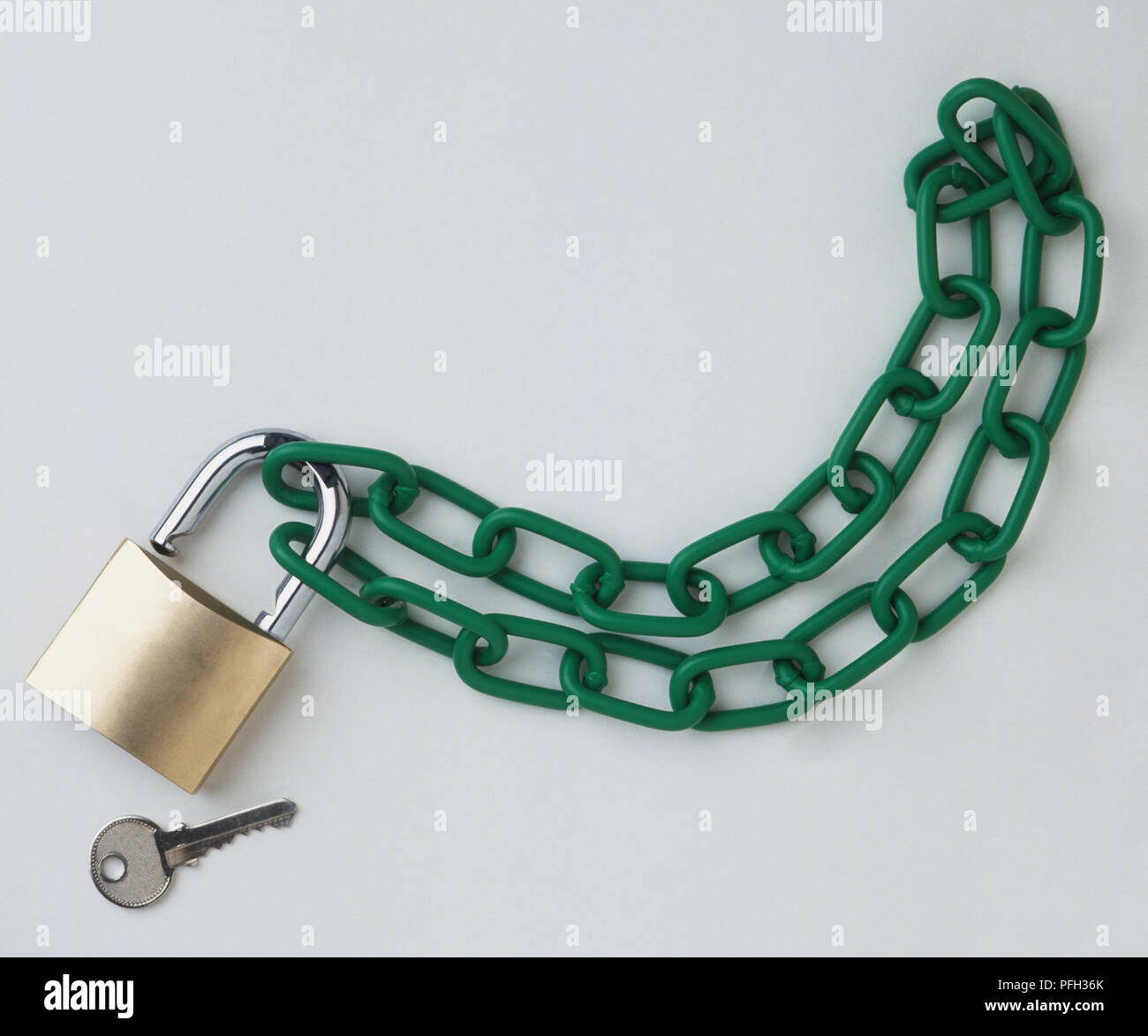 Green chain looped with padlock, close up Stock Photo - Alamy